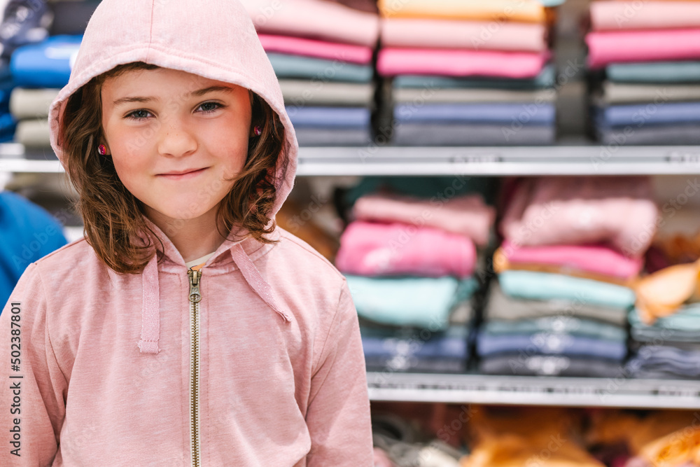 Little girl in clothes shop Stock Photo | Adobe Stock