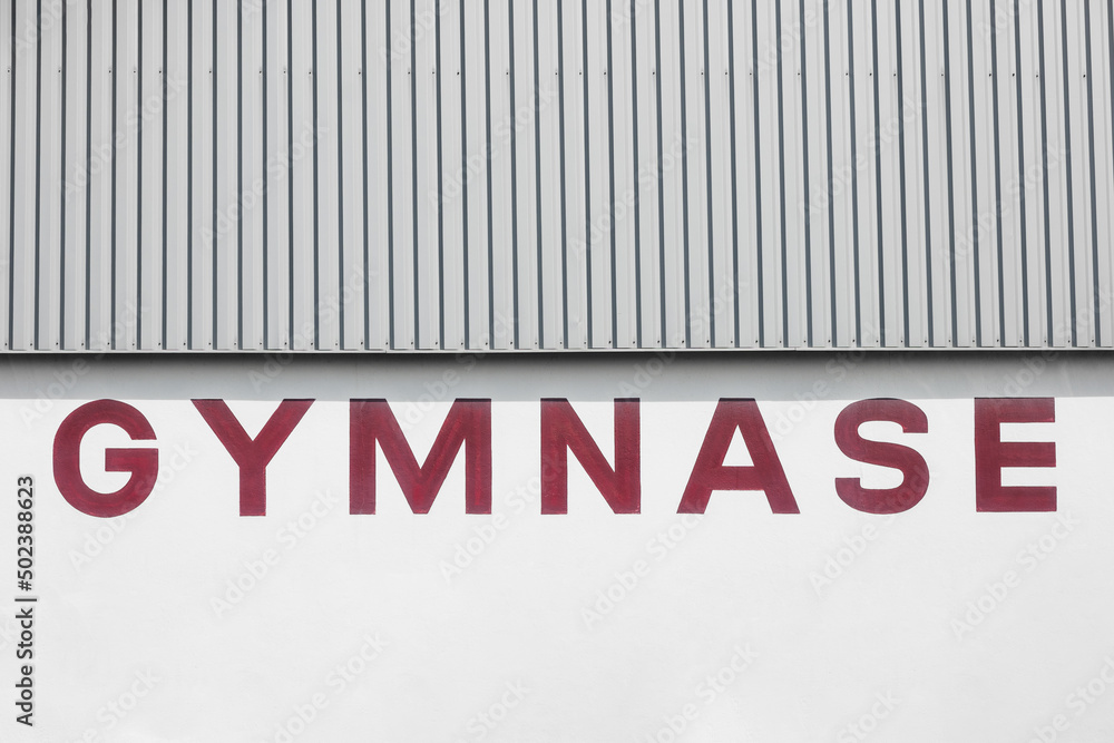 Inscription on white building of gymnasium in daylight Stock Photo ...