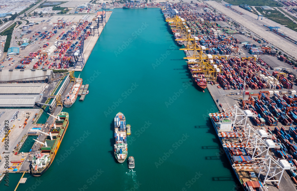 container ship at sea port and working crane bridge loading un loading ...