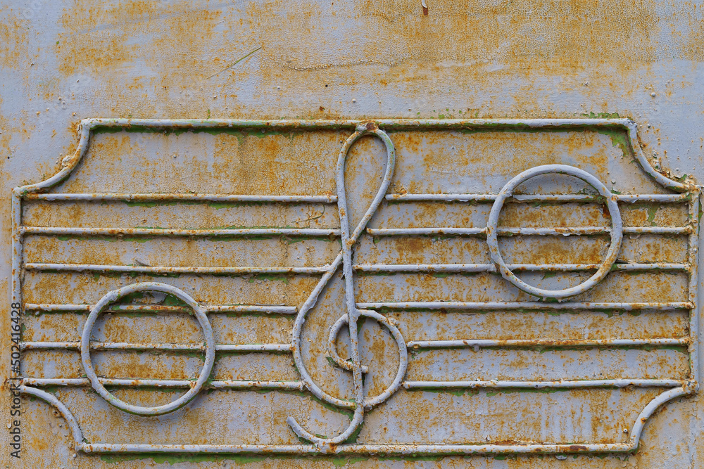 Metal fence of the old music school with decorative symbols in the form ...