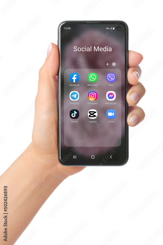 Hand holds mobile phone with icons of popular social media mobile apps ...