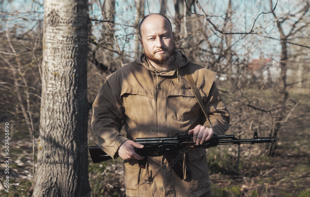 warrior with a machine gun in his hands is on the defensive Stock Photo ...