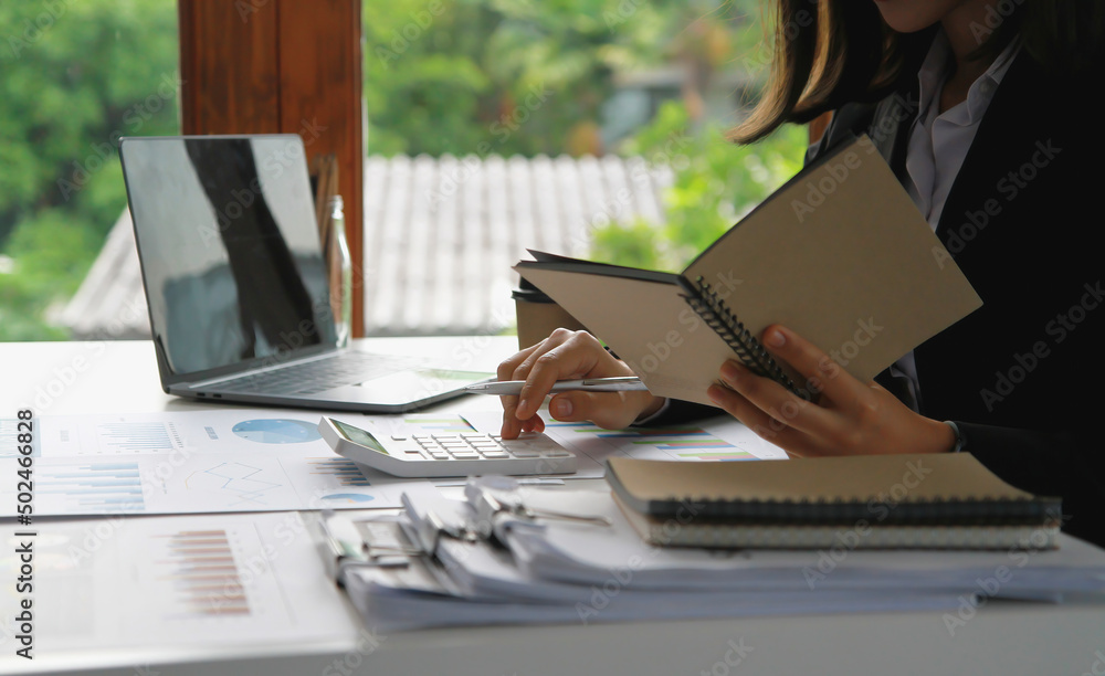 Financial advisor calculating numbers datasheets graphs charts reports ...