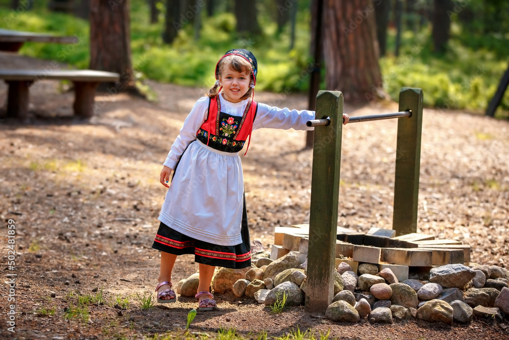 Adorable little girl in Swedish traditional clothes during Midsommar ...