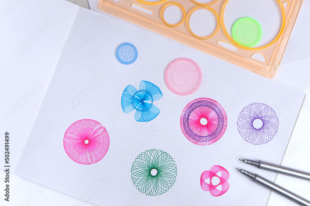 Spirograph ruler on white background. Drawing the spirograph pattern on ...