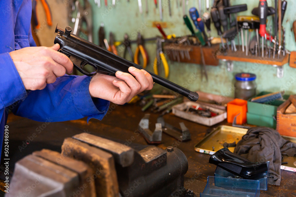 Dismantling and repair of combat pistol in a weapons workshop Stock ...