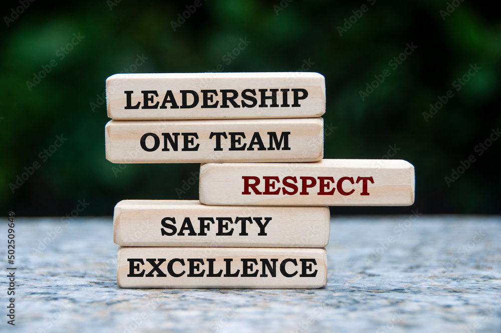 Leadership, one team, respect, safety and excellence text on wooden ...