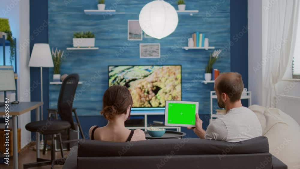 Static video of couple looking at digital tablet with green screen ...