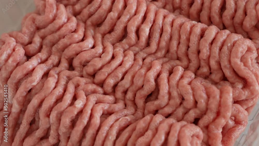 Closeup view 4k video footage of fresh raw minced or grounded organic ...