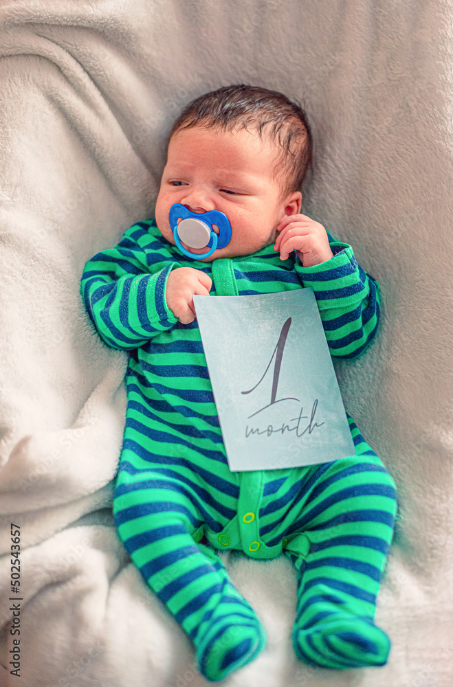 Cute baby with 1 month old milestone card in his hand Stock Photo ...