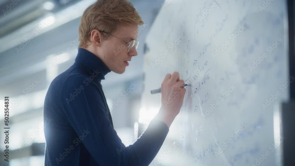 Young Male Scientist Writing Various High School Maths and Science ...