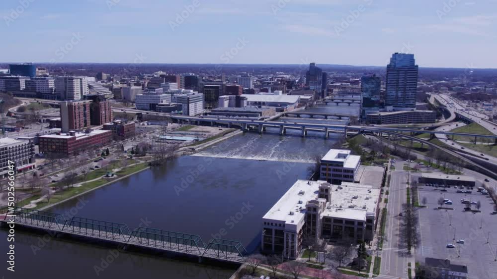 Grand River, Grand Rapids skyline and distant horizon, wide aerial pan ...
