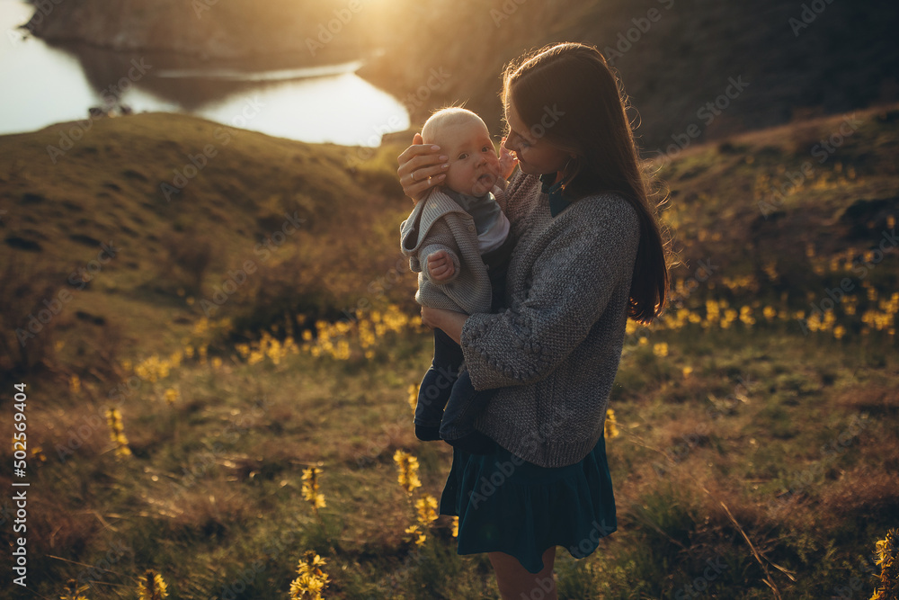 Woman and baby in nature. Mom and baby are relaxing in the park. High ...