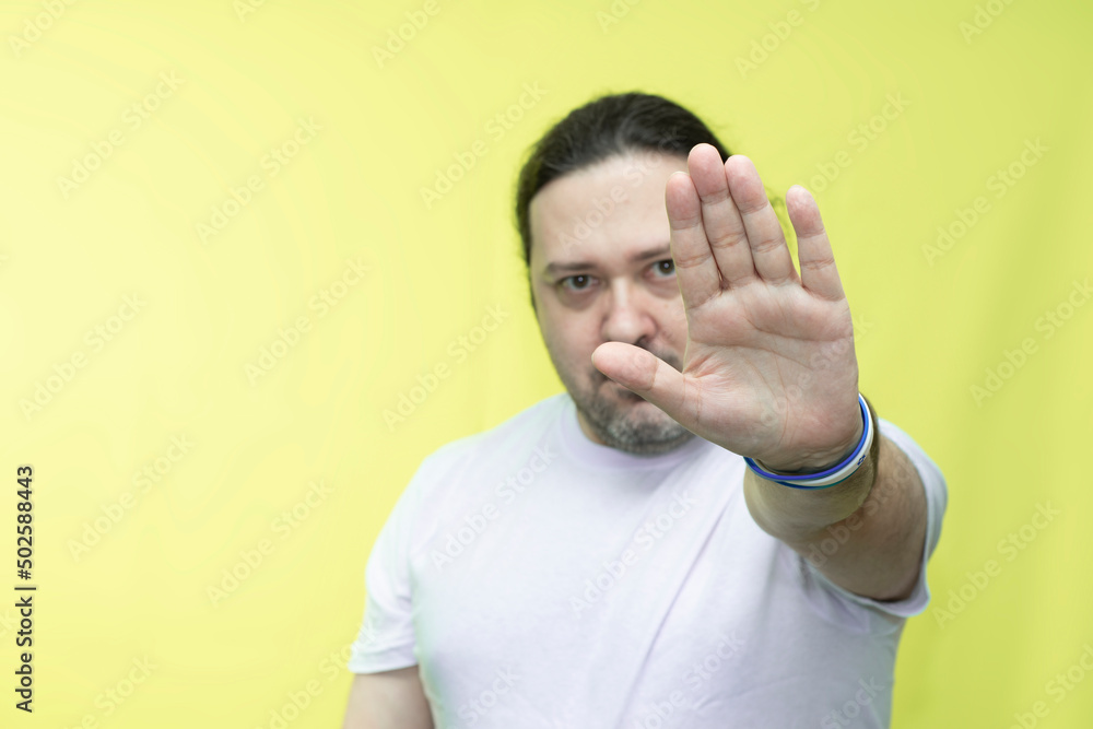 An adult man shows a stop sign with his hand. An outstretched hand with ...
