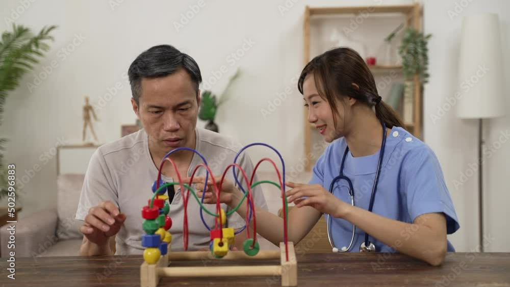 smiling asian female nurse giving instructions while helping older man ...