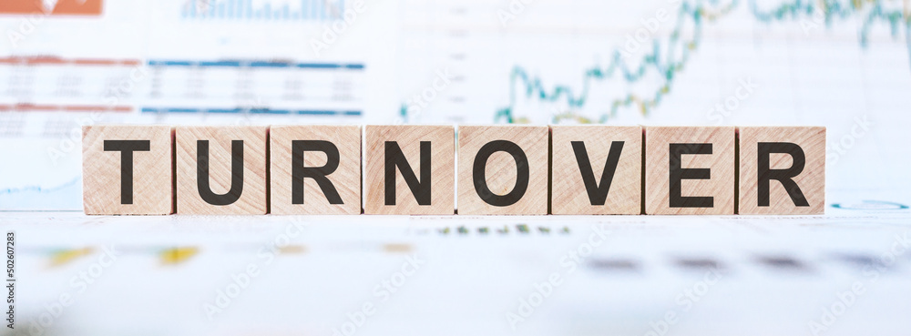 On a light background, graphs, diagrams and wooden cubes with the word ...