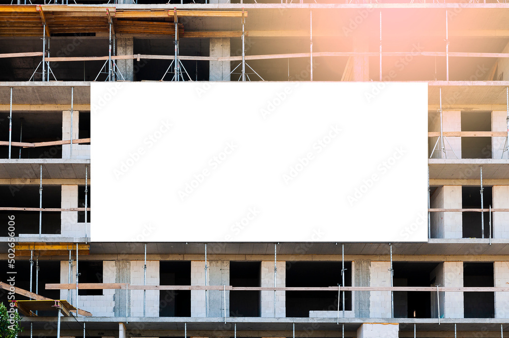 Blank white banner for advertisement on the facade of the building ...