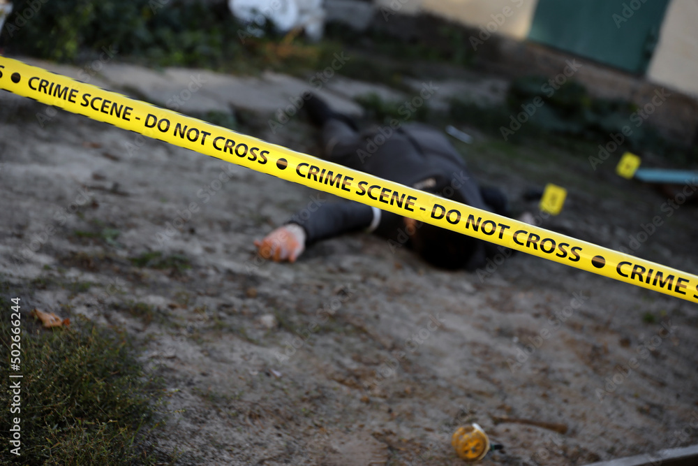 Victim of a violent crime in a backyard of residental house in evening ...