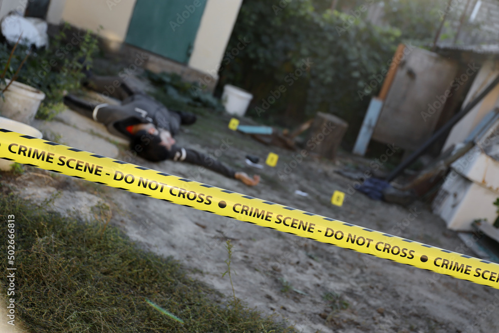 Victim of a violent crime in a backyard of residental house in evening ...