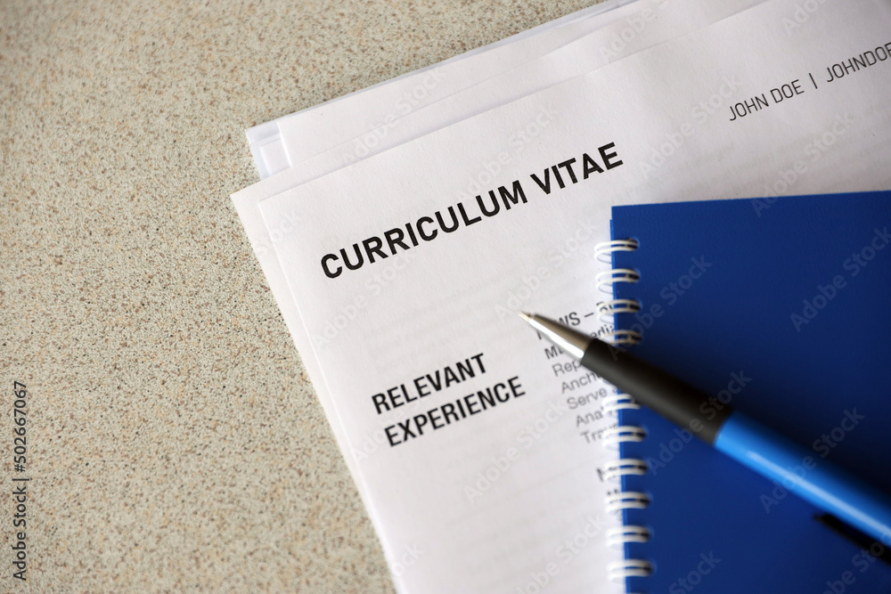 Top view of stack of office documents including resume and cv forms on ...