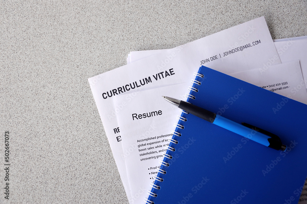 Top view of stack of office documents including resume and cv forms on ...