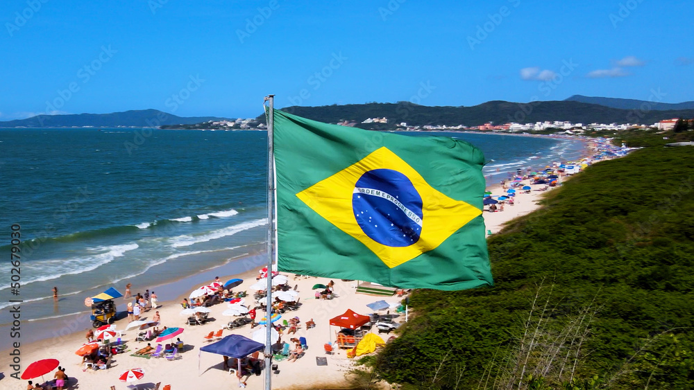 Brazilian flag fluttering in the wind on paradise beach hoisted flag ...