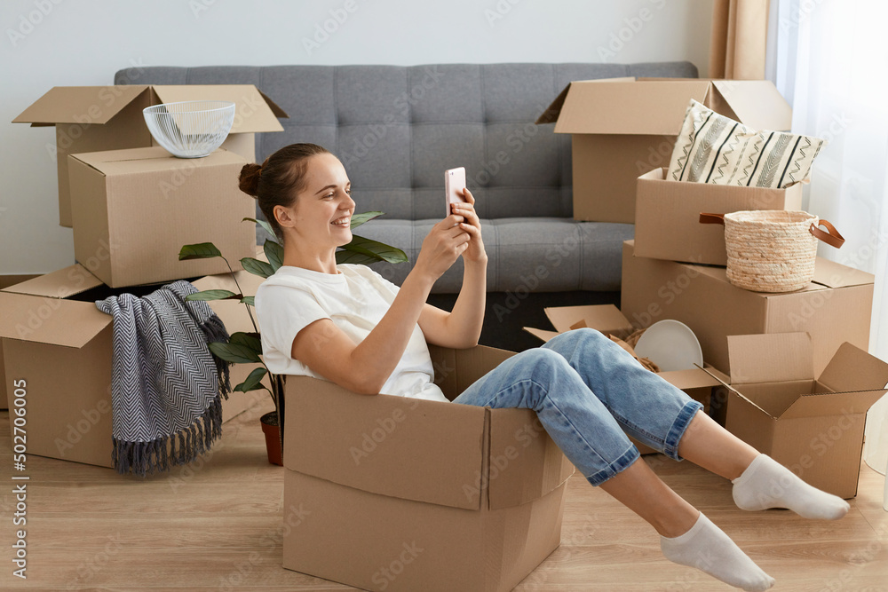 Side view of positive optimistic woman wearing white t shirt and jeans ...