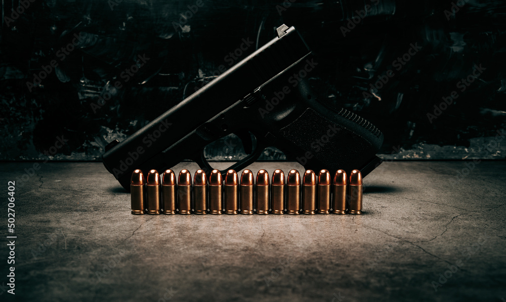 Portrait shots of 9mm bullets lined up on an old concrete floor with a ...