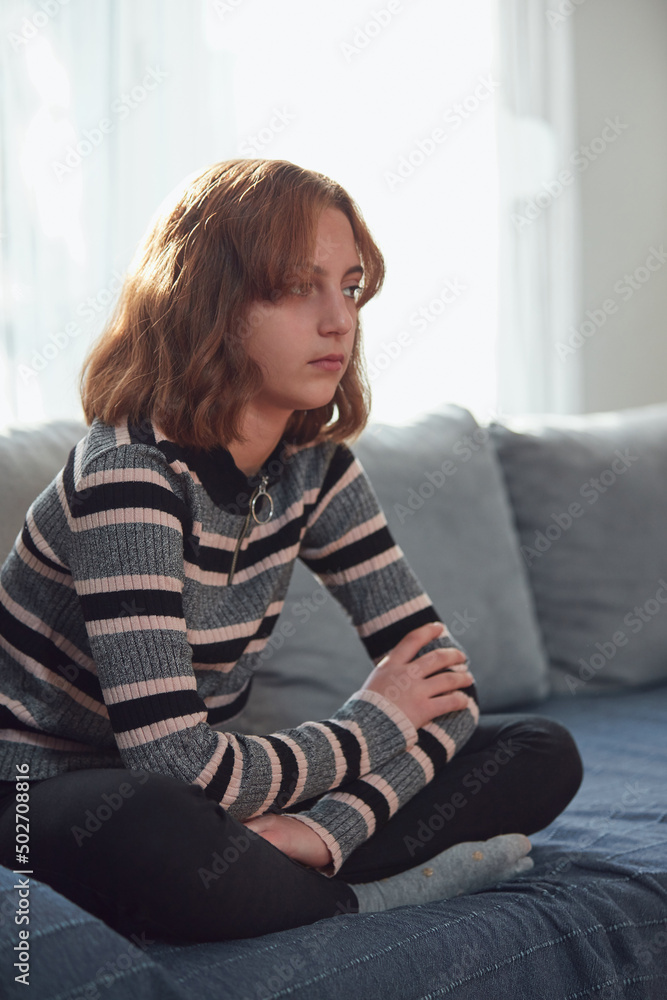 Teenage girl being bored and difficult at home. Stock Photo | Adobe Stock