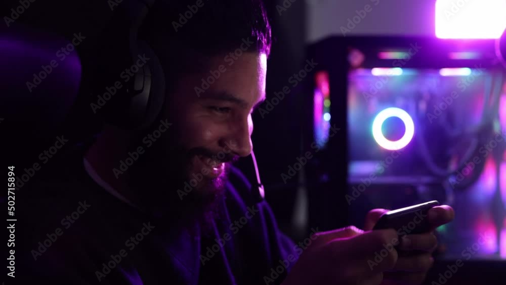 A Young Men Playing Mobile Games In A Computer Game Room Dark Room With Colorful Neon Lights The 2484