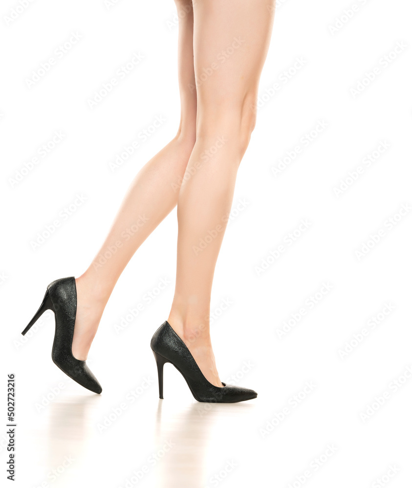 Perfect female legs wearing high heels isolated on white background ...