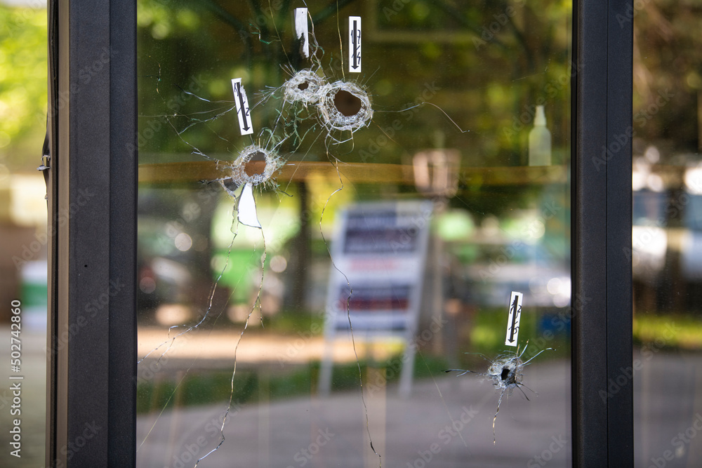 Bullet holes on the window of local restaurant, shot during war ...