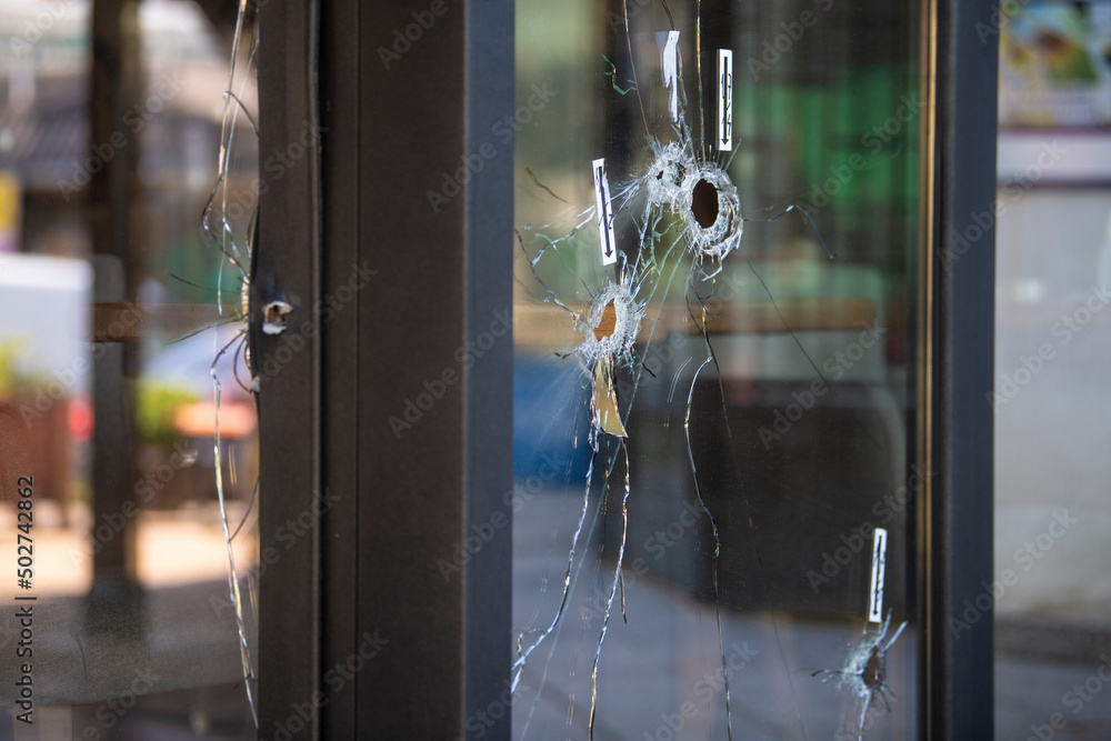 Bullet holes on the window of local restaurant, shot during war ...