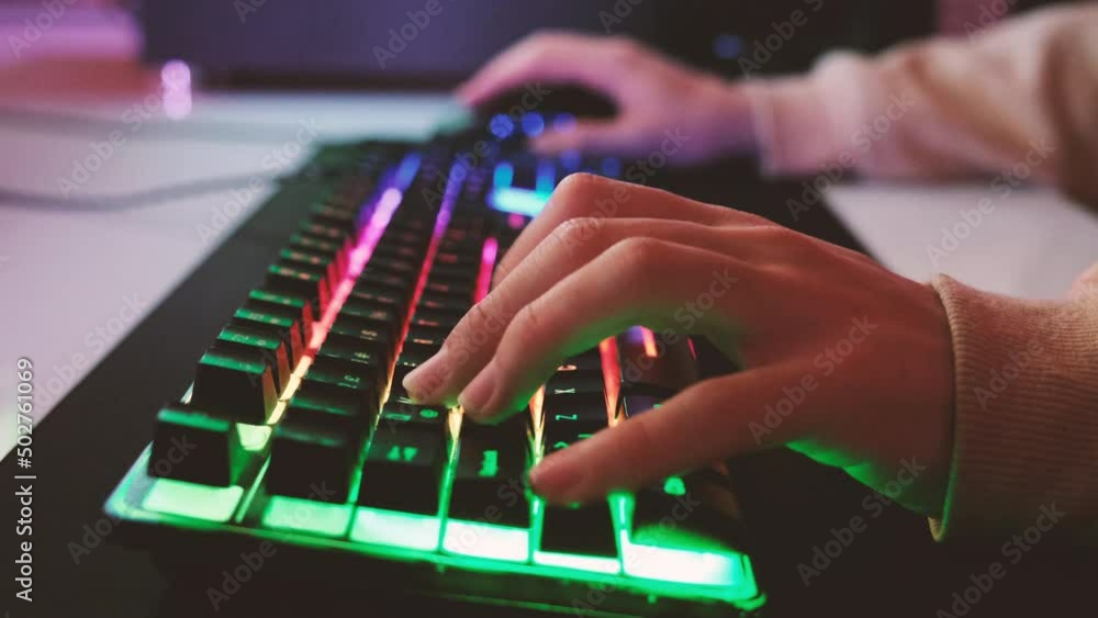 Gamer hands, gamer hands on RGB keyboard, closeup footage of gamer ...