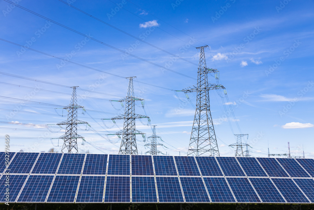 Solar panels, high voltage electricity towers, and transmission power ...