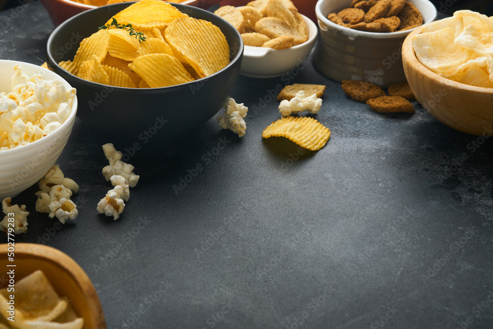 Unhealthy food. Snacks. All classic potato snacks with peanuts, popcorn ...