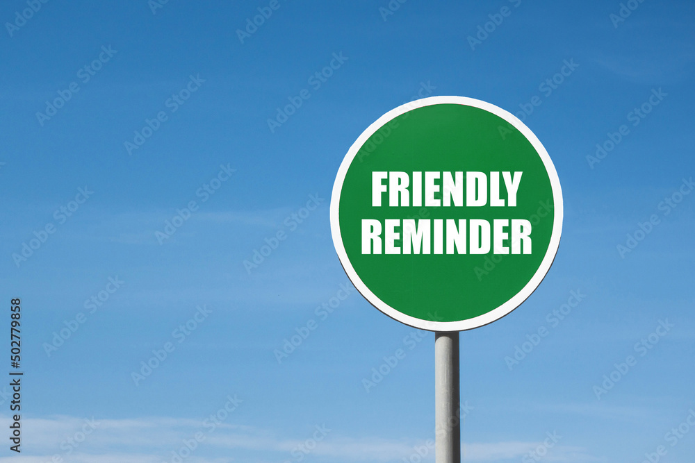 'Friendly reminder' sign in green round frame. Clear blue sky is on background Stock Photo ...