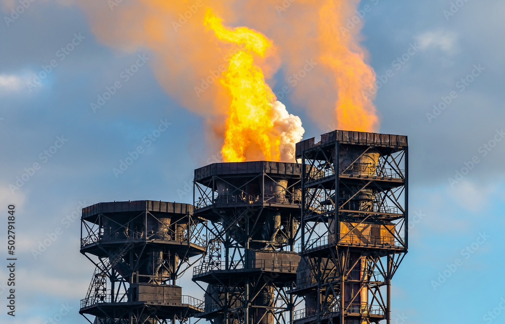 Burning gas torch with thick poisonous smoke close-up. Gas processing ...