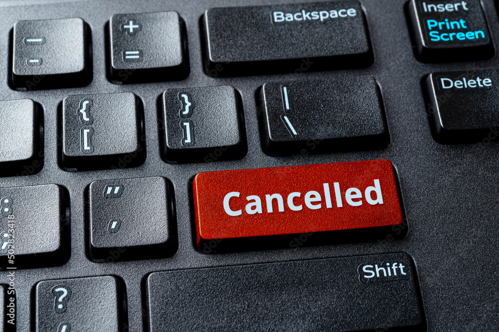 Canceled word on a red enter key of the black pc keyboard. Concepts of ...