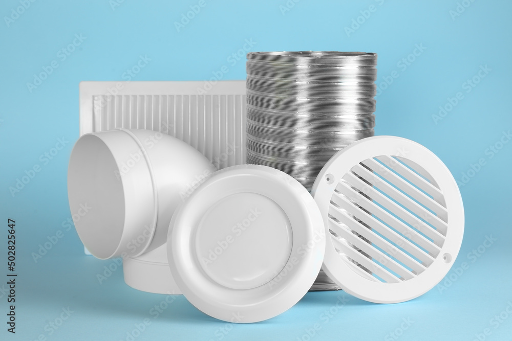 Parts of home ventilation system on light blue background Stock Photo ...
