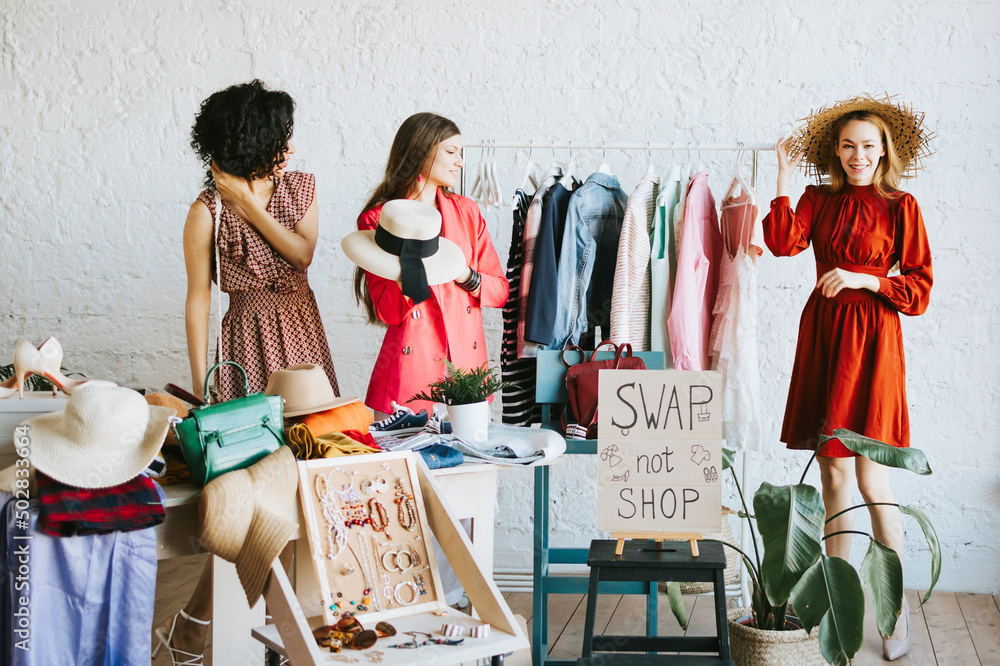 three young woman female caucasian and african students at swap party ...