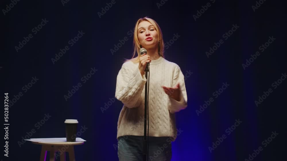Stand-up cafe, woman comedy concert. Woman telling jokes on stage ...