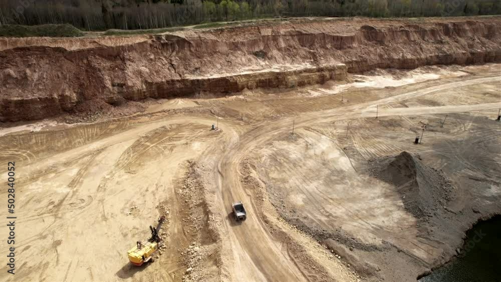 Mining truck transports limestone from opecast, drone view. View of an ...
