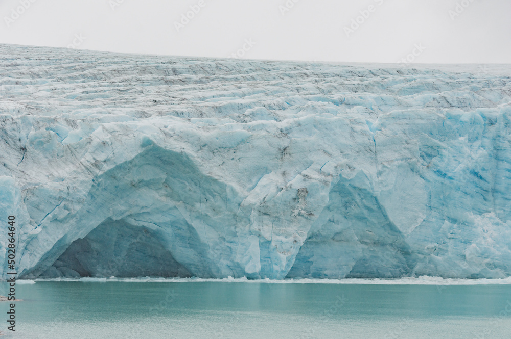 Melting blue ice of Austdalsbreen glacier and water of Styggevatnet ...