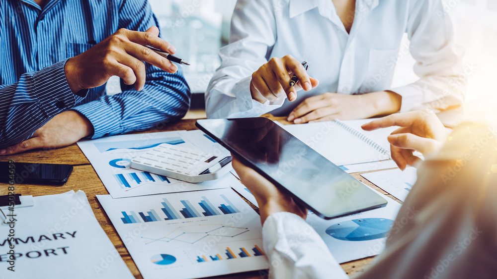 Team work discussing in valuation data in meeting room, three business ...