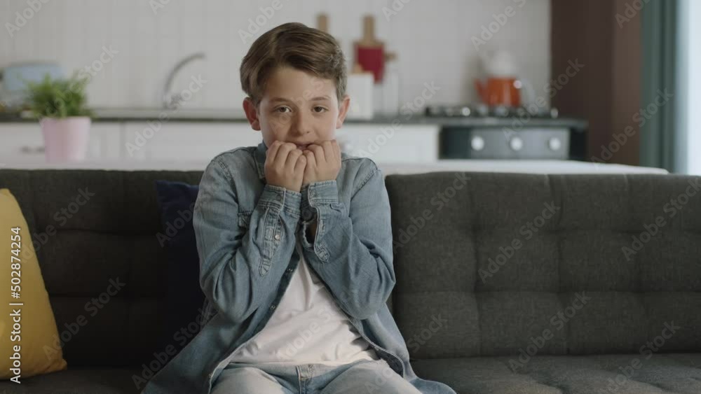 Portrait of a sad, anxious child who is bored at home.Lonely, scared ...