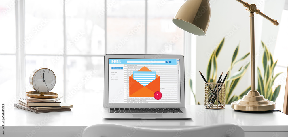 Laptop with symbol of new unread message on screen at workplace Stock ...