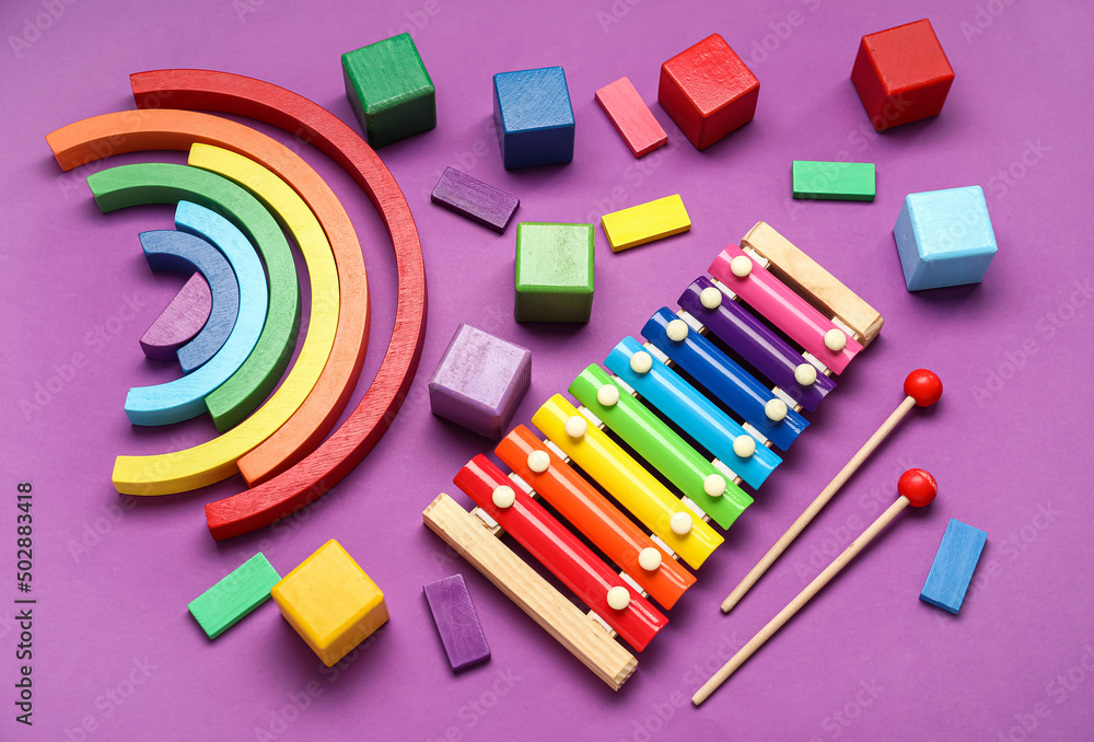 Wooden cubes with blocks and xylophone on purple background Stock Photo ...