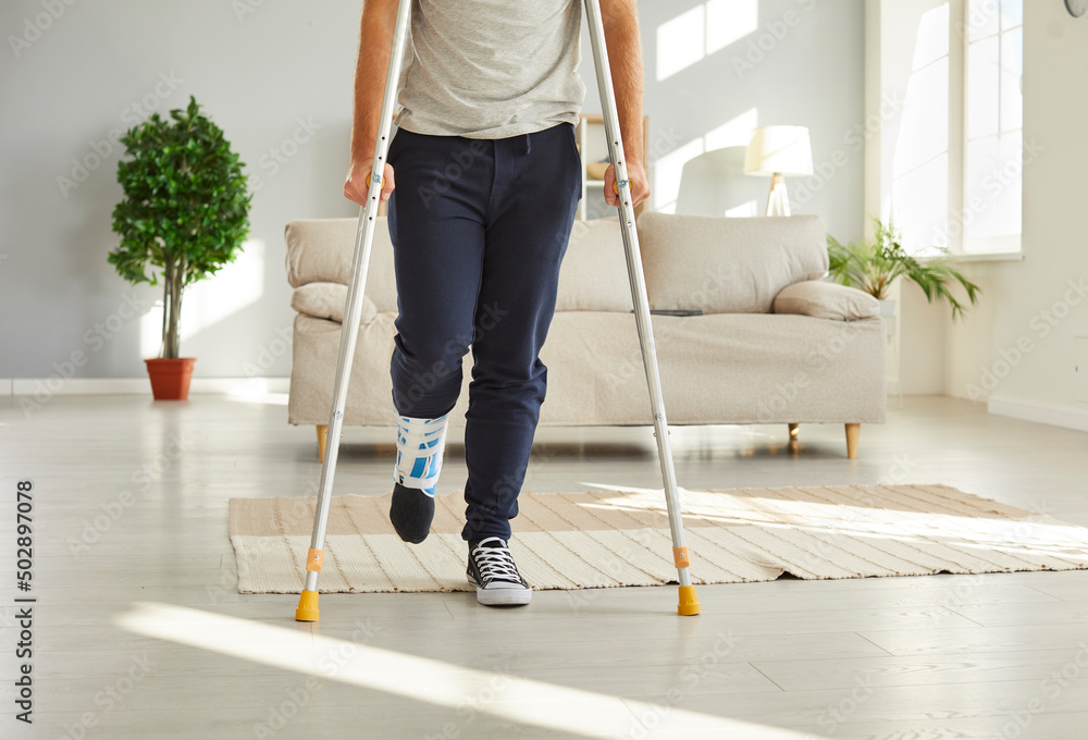 Closeup crop of unhealthy injured man with bandage on foot walk on ...