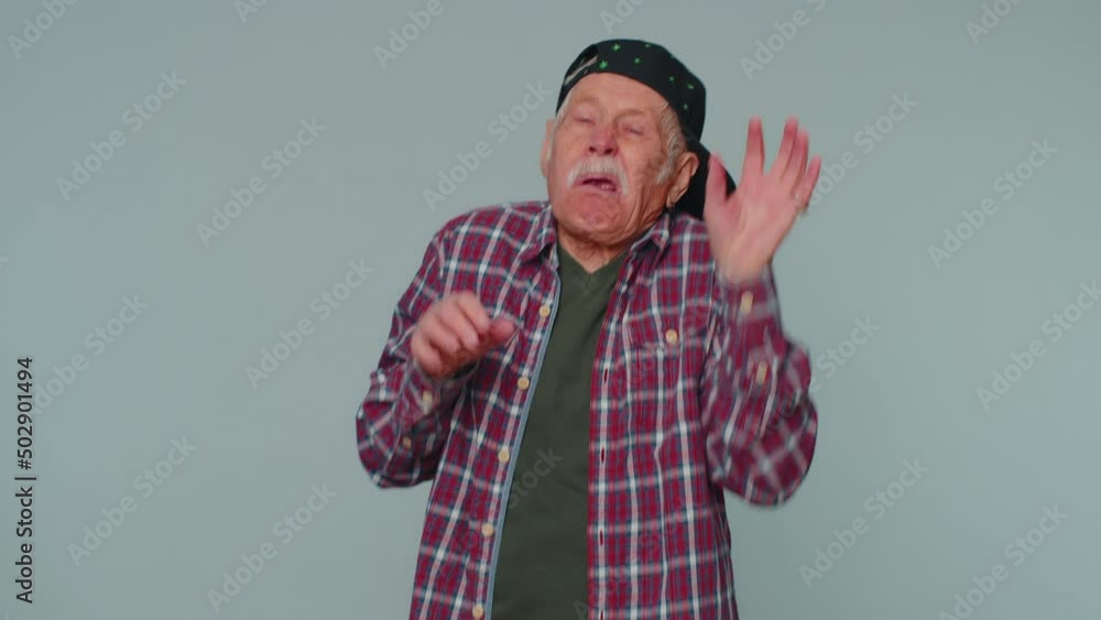 Funny joyful sincere mature man 80 years old making playful silly ...